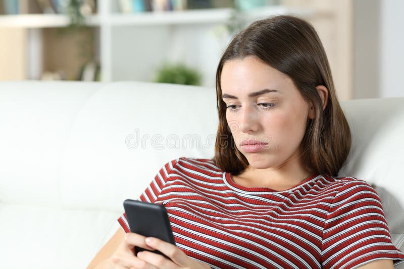 Sad Teen Checking Phone at Home Stock Image - Image of concerned ...