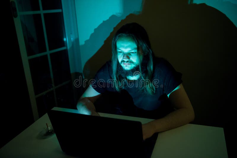 Bored User is Looking at His Computer Browsing through the Internet ...