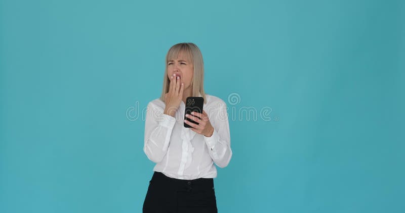Bored Woman Yawning with Phone on Blue Background Stock Footage - Video ...