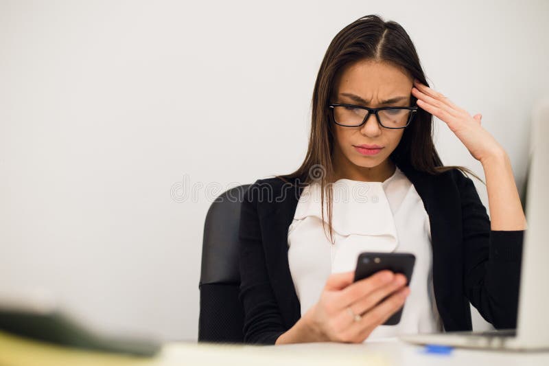 Bored Woman at Her Desk Typimg Message on Mobile Phone Stock Photo ...