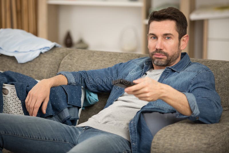 Bored Young Man Holding Tv Remote Control Stock Image - Image of ...