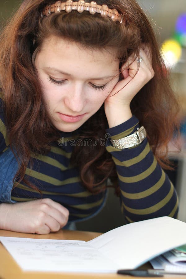Bored Young Student Reading Text Stock Photo - Image of girl ...