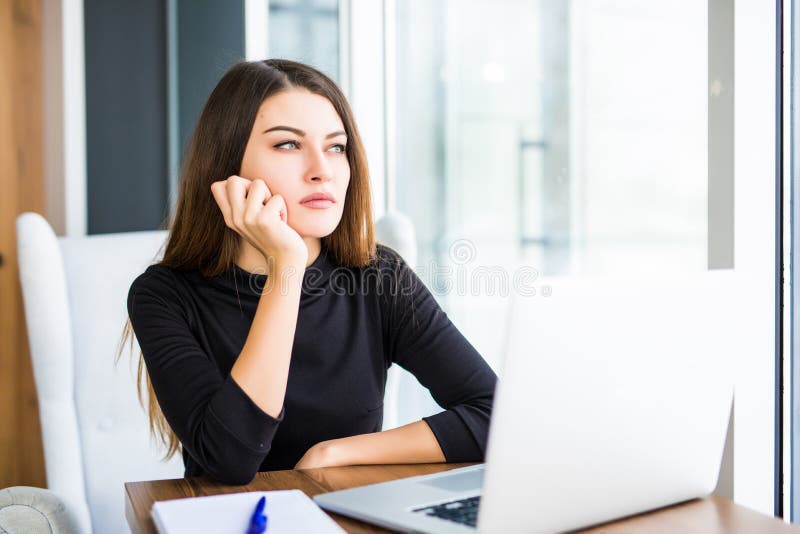 Bored Young Woman in the Office Working with a Laptop Stock Image ...