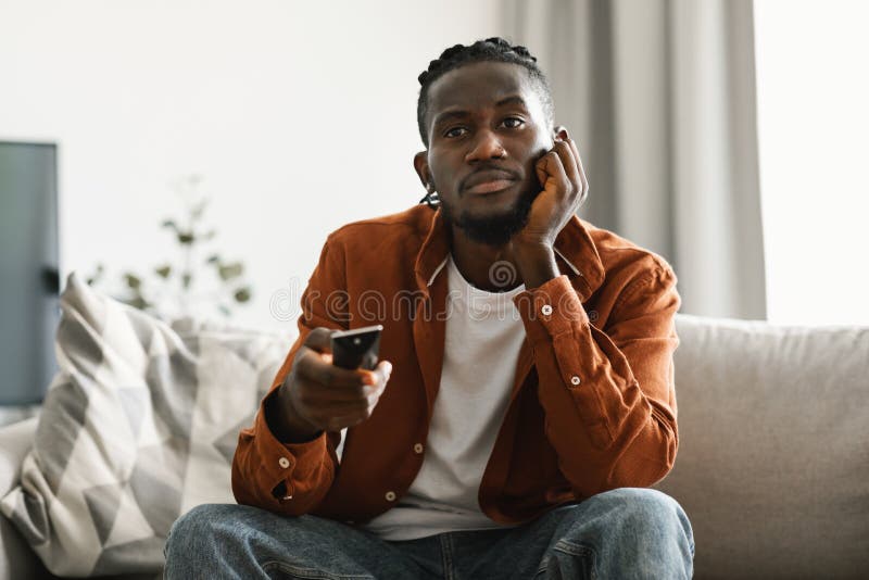 Boring Show. Portrait of Upset Young Indian Guy Watching TV at Home ...