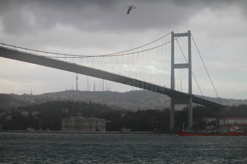 Bosphorous Bridge and a Red Ship in Istanbul, Turkey Stock Image ...