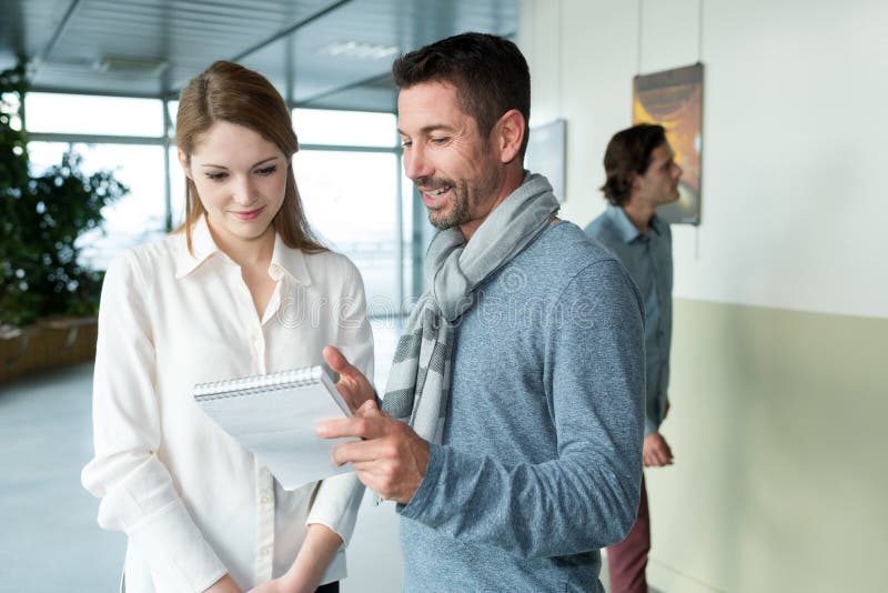 Boss and Assistant Working in Corridor Stock Photo - Image of ...