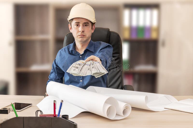 The Boss in the Construction Helmet at the Desk with the Design ...