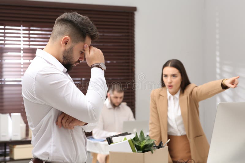 Boss Dismissing Young Man from Work in Office Stock Image - Image of ...