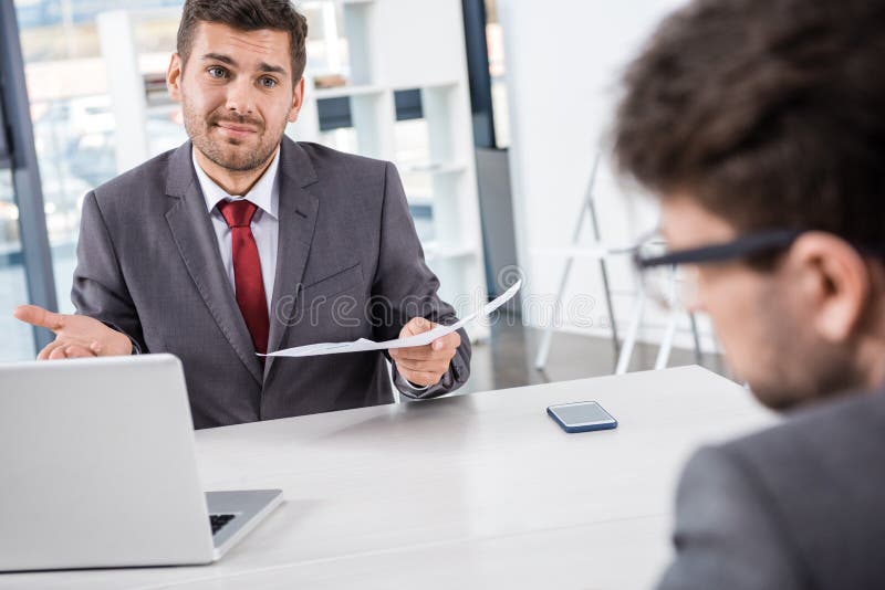 Boss with Documents Looking at Colleague at Business Meeting Stock ...