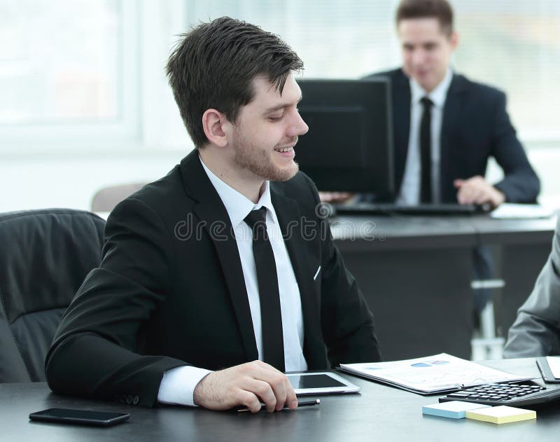 Boss and Employee Discussing the Document Sitting at the Desk in the ...