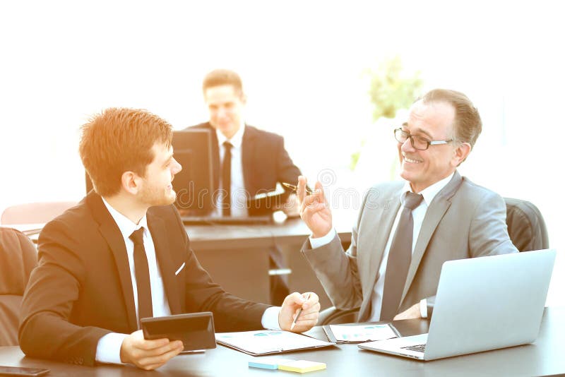 Boss and Employee Discussing the Document Sitting at the Desk in the ...