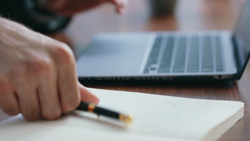 Boss Hands Noting Information in Notebook Working on Laptop Close Up ...