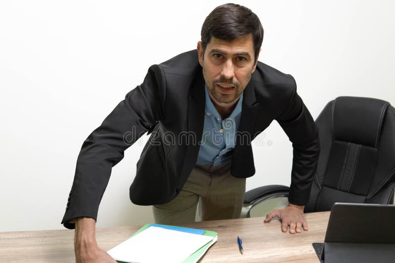 Boss in Office with Aggressive Pose Looking at and Approaching Camera ...