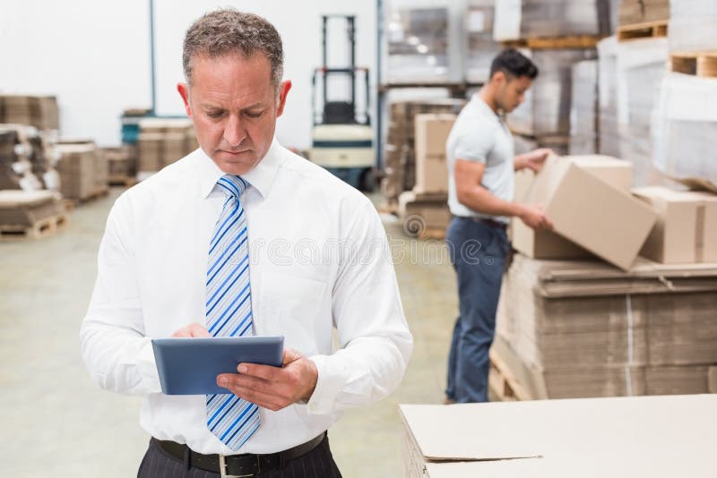 Boss Using Digital Tablet in Warehouse Stock Photo - Image of people ...