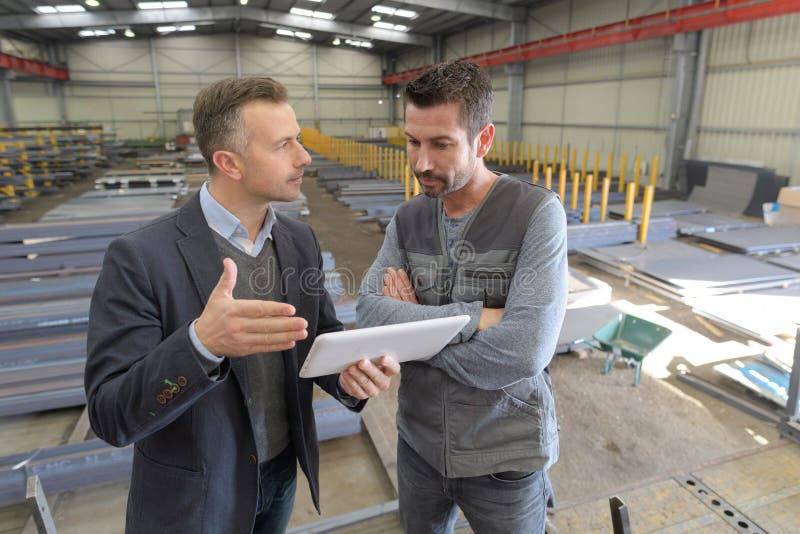 Boss and Worker in Conversation in Factory Stock Image - Image of ...