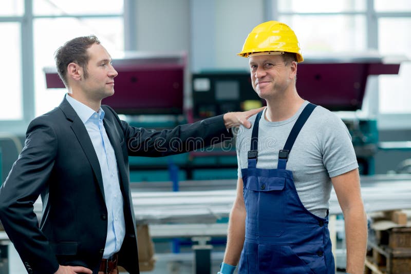 Boss and worker in factory stock image. Image of industrial - 47054013