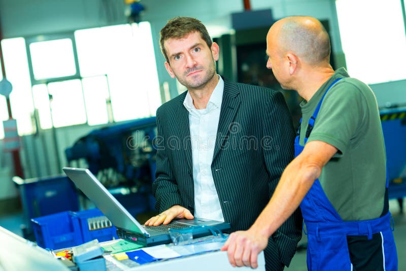 Boss and Worker on Work Bench Stock Image - Image of positive, control ...