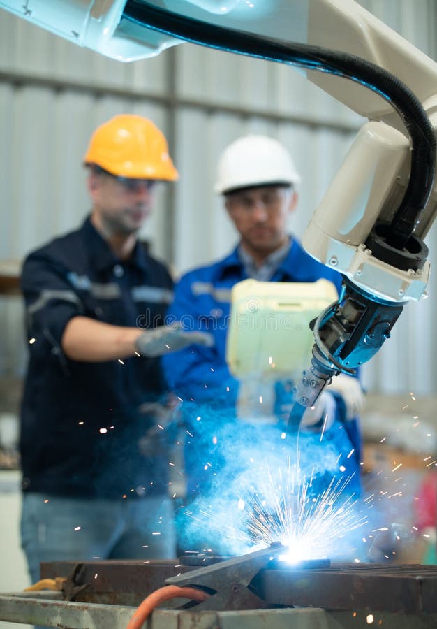 Both of Engineers are Manipulating a Welding Robot Hand. by Combining ...