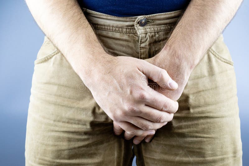 Hands on the groin stock image. Image of confusion, belly - 79555431