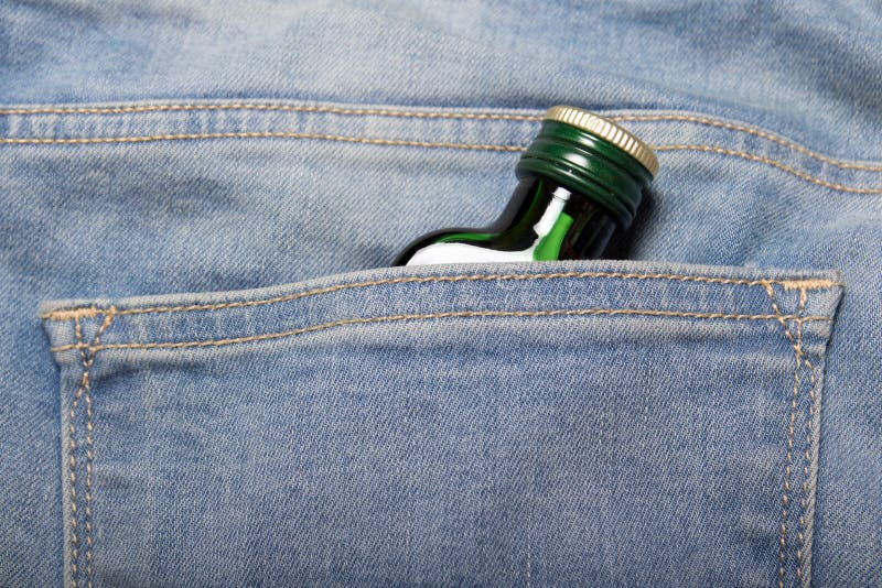 Bottle with Alcohol in Back Pocket of Blue Jeans Stock Image - Image of ...