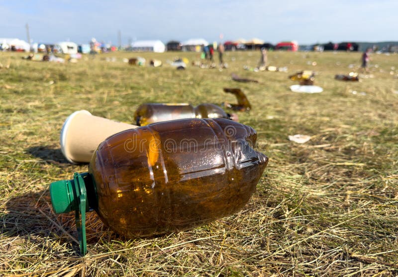 A Bottle of Beer is Laying on the Grass in a Field Stock Image - Image ...