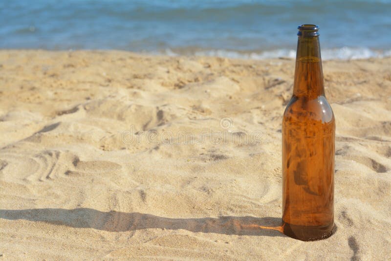 Bottle of Beer on Sandy Beach Near Sea. Space for Text Stock Image ...