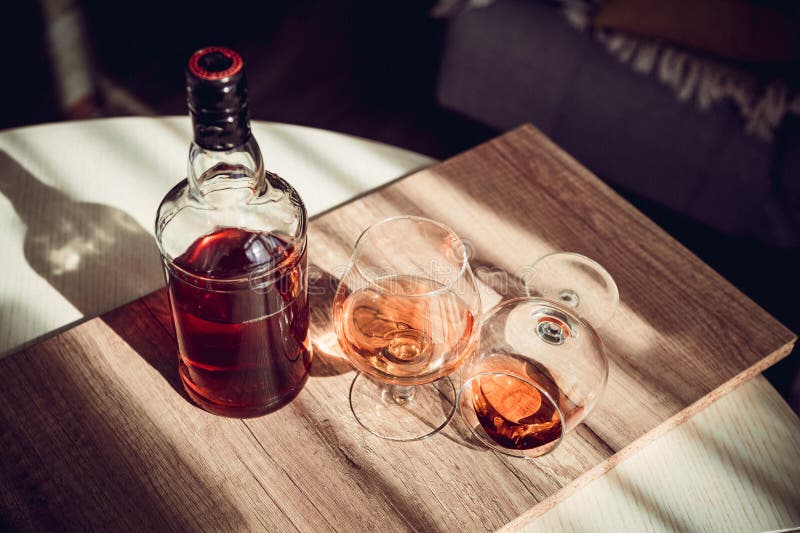Bottle of Brandy and Two Glasses of Alcohol in a Bar Stock Image ...
