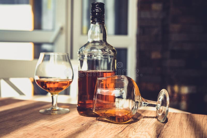 Bottle of Brandy and Two Glasses of Alcohol in a Bar Stock Image ...