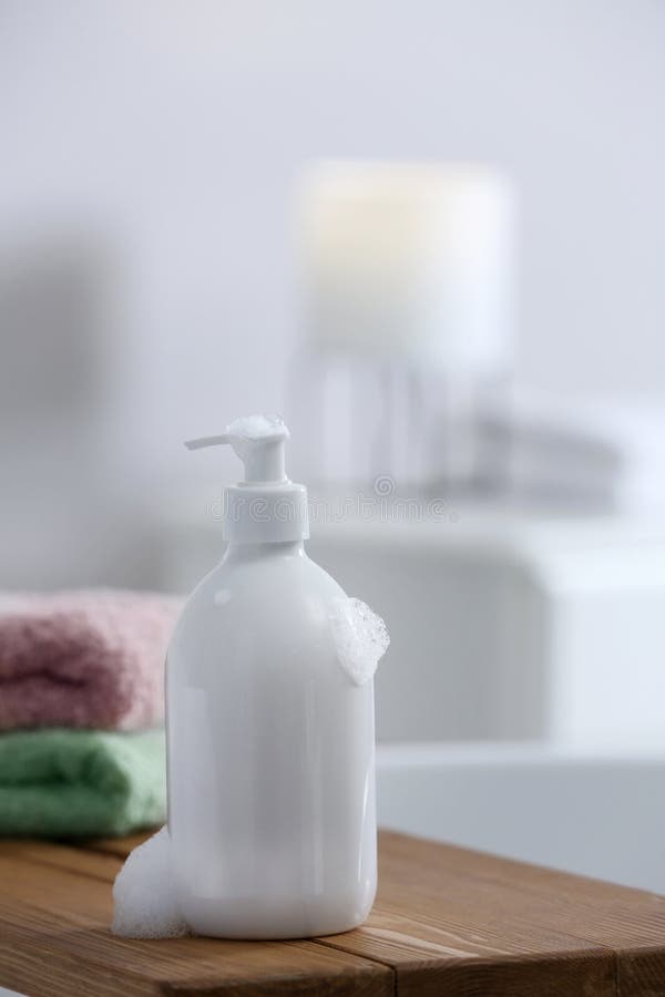 Bottle of Bubble Bath with Foam and Towels on Tub in Bathroom Stock ...
