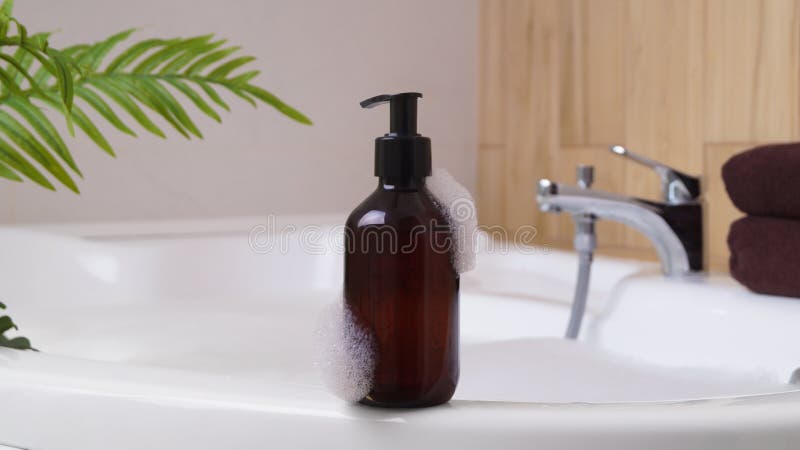 Bottle of Bubble Bath with Foam on Tub Indoors Stock Photo - Image of ...