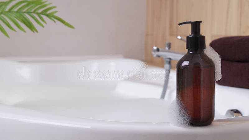 Bottle of Bubble Bath with Foam on Tub Indoors, Space for Text Stock ...