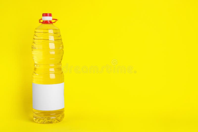 Bottle of Cooking Oil on Yellow Background. Space for Text Stock Photo ...