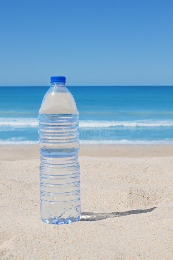 A Bottle of Cool Water on the Beach Near the Sea. Stock Photo - Image ...