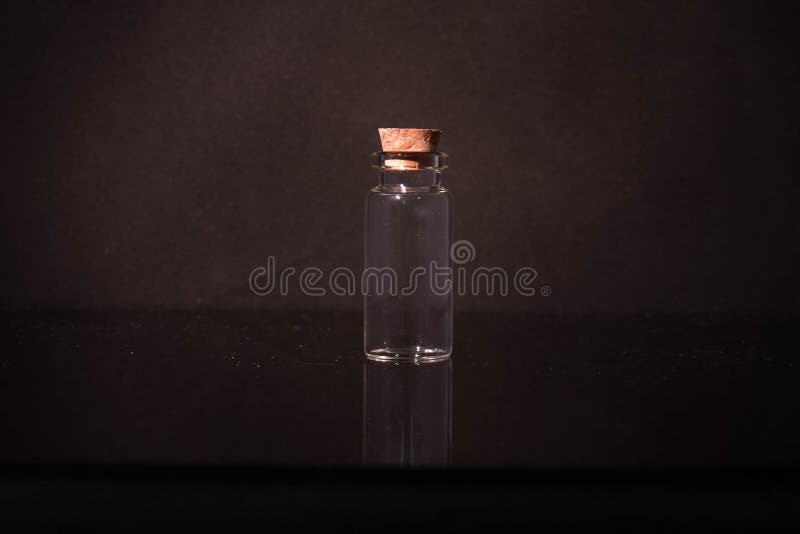 A bottle in the dark stock photo. Image of hand, minute - 73934086