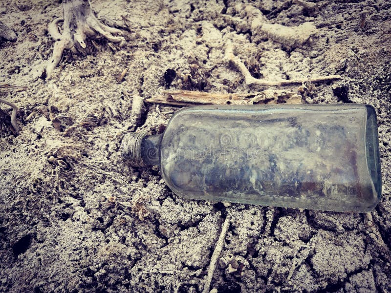 Bottle in Dried Cracked Mud. Stock Photo - Image of environment, land ...