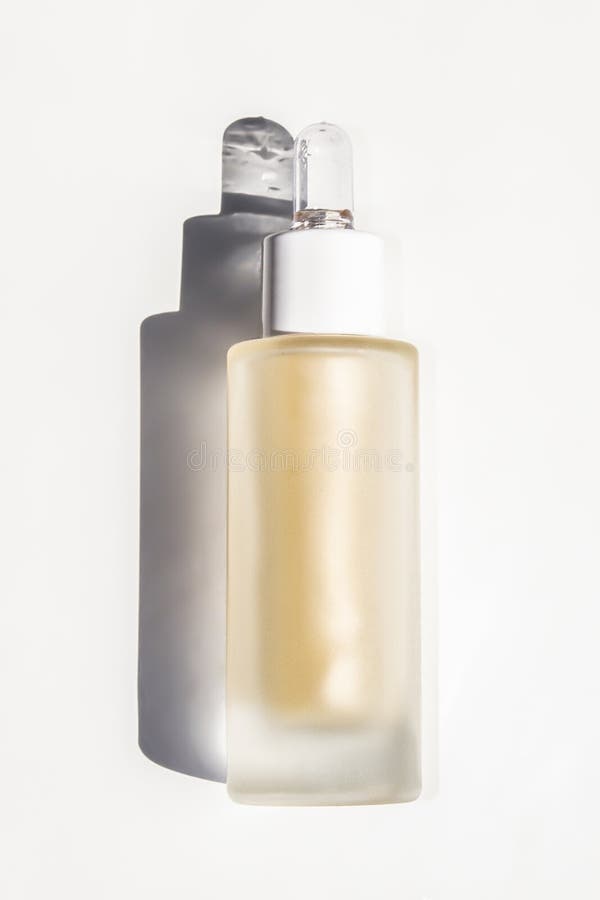 Bottle with a Dropper and Yellow Liquid. Serum for the Face. Stock ...
