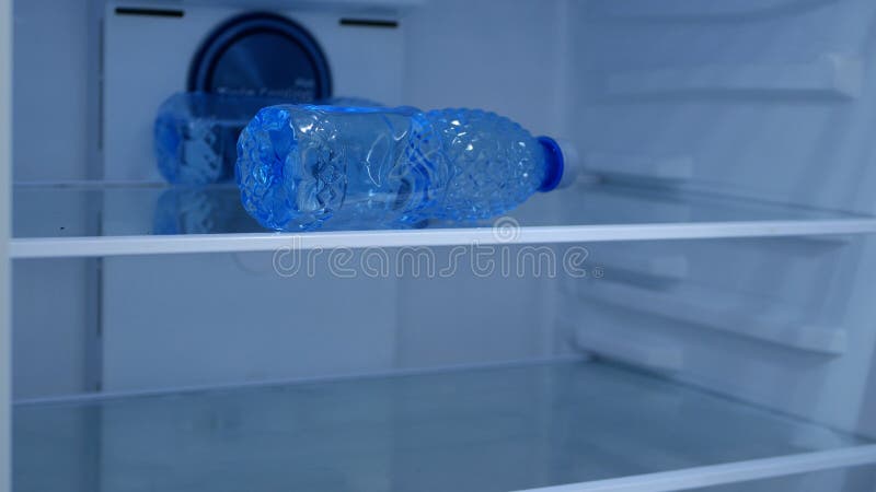 A Bottle with Fresh and Cold Water in the Kitchen Fridge Stock Image ...