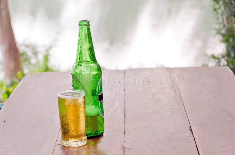 Bottle and Glass with Beer on Wood Table Stock Image - Image of filled ...
