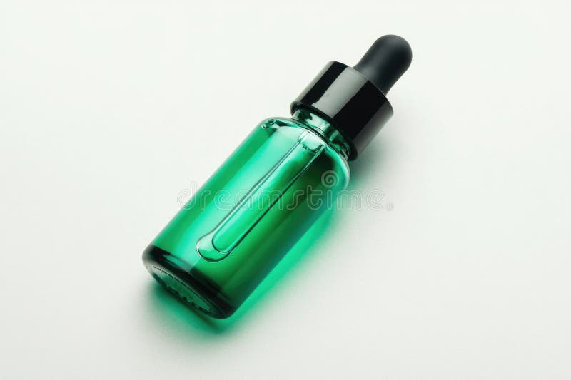 A Bottle of Green Liquid Sitting on a White Surface, Perfect for ...