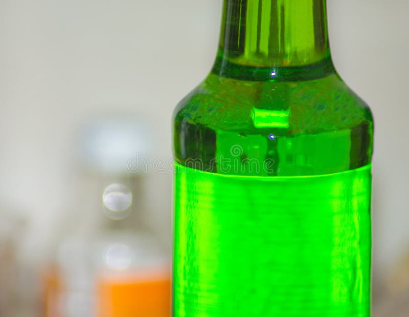 A Bottle of Green Sweet Syrup on a Blurred Background Stock Photo ...