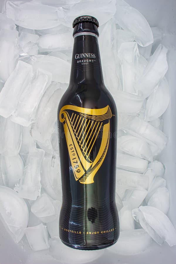 Bottle of Guinness Extra Stout on Ice Editorial Image - Image of ...