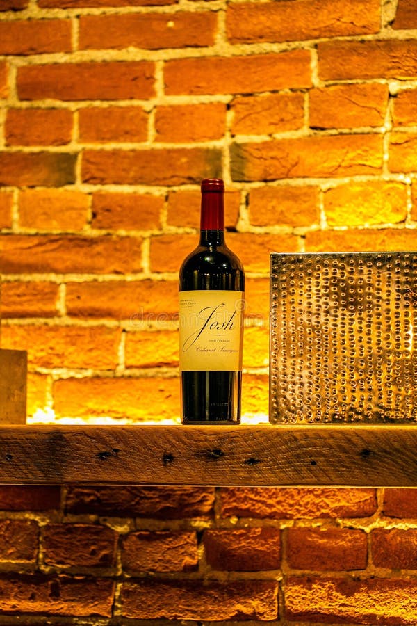 Bottle of Josh Cellars Wine Sitting on a Wooden Shelf Illuminated with ...