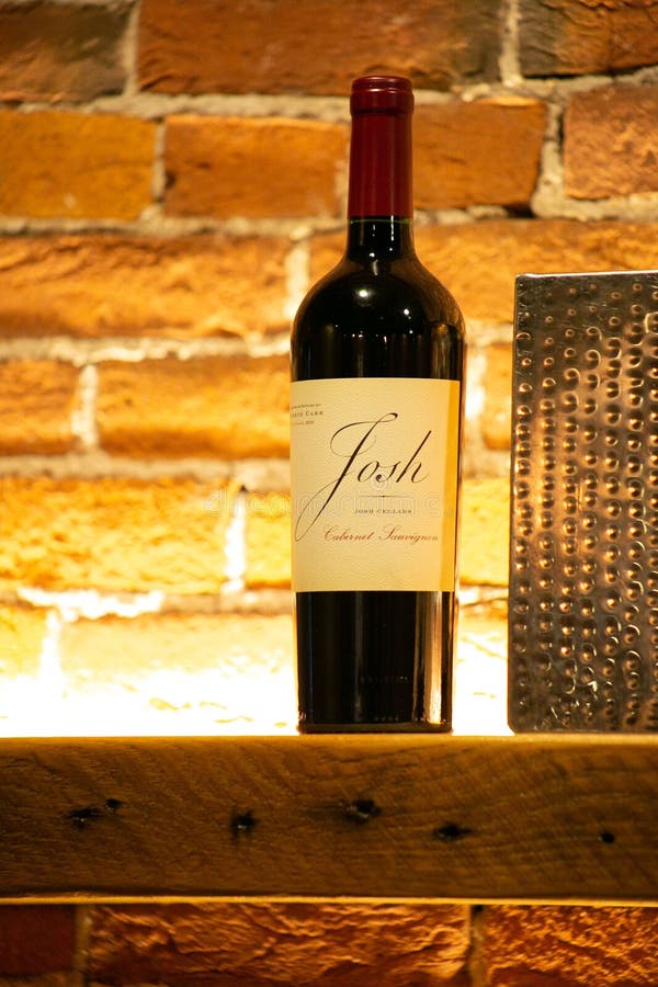 Bottle of Josh Cellars Wine Sitting on a Wooden Shelf Illuminated with ...