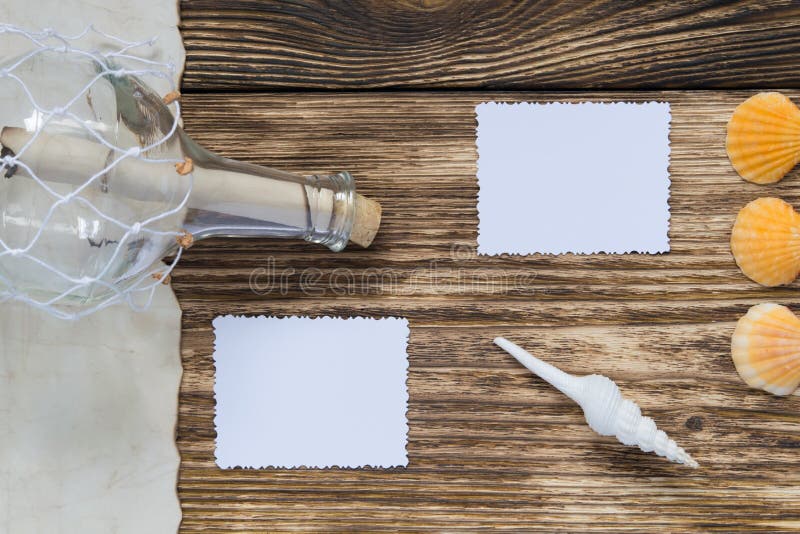 Bottle with a Message on the Table and Two Blank Photos Stock Photo ...