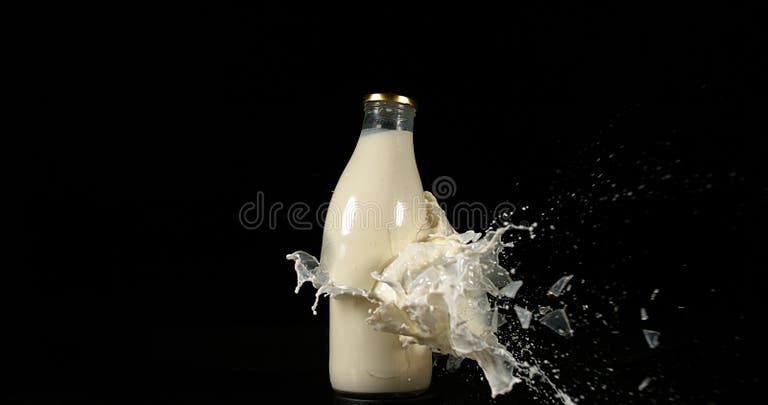 Bottle of Milk Exploding Against Black Background Stock Image - Image ...