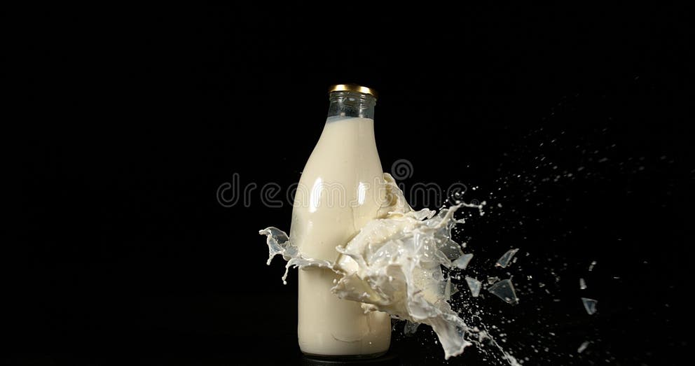 Bottle of Milk Exploding Against Black Background Stock Image - Image ...