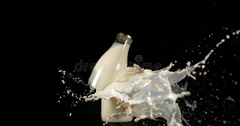 Bottle of Milk Exploding Against Black Background Stock Photo - Image ...