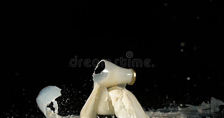 Bottle of Milk Exploding Against Black Background Stock Photo - Image ...