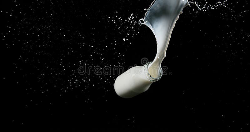 Bottle of Milk Falling and Exploging Against Black Background Stock ...