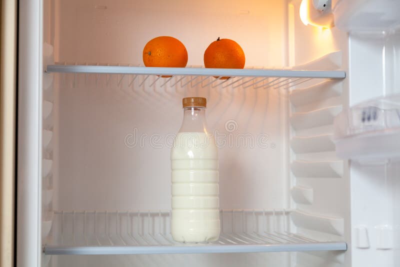 Bottle of Milk and Oranges Stand in Empty Fridge Stock Image - Image of ...
